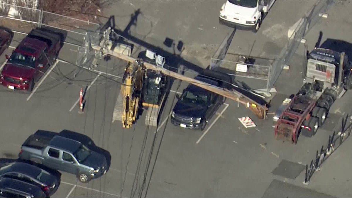Excavator strikes wires, trapping worker inside construction equipment