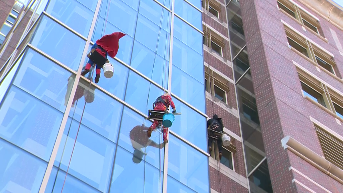 Window washers dressed as superheroes descend outside windows of Boston ...