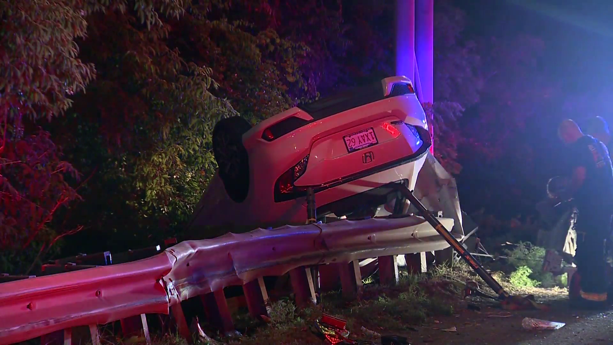 Car flips over guardrail in crash on Interstate 93 in Boston