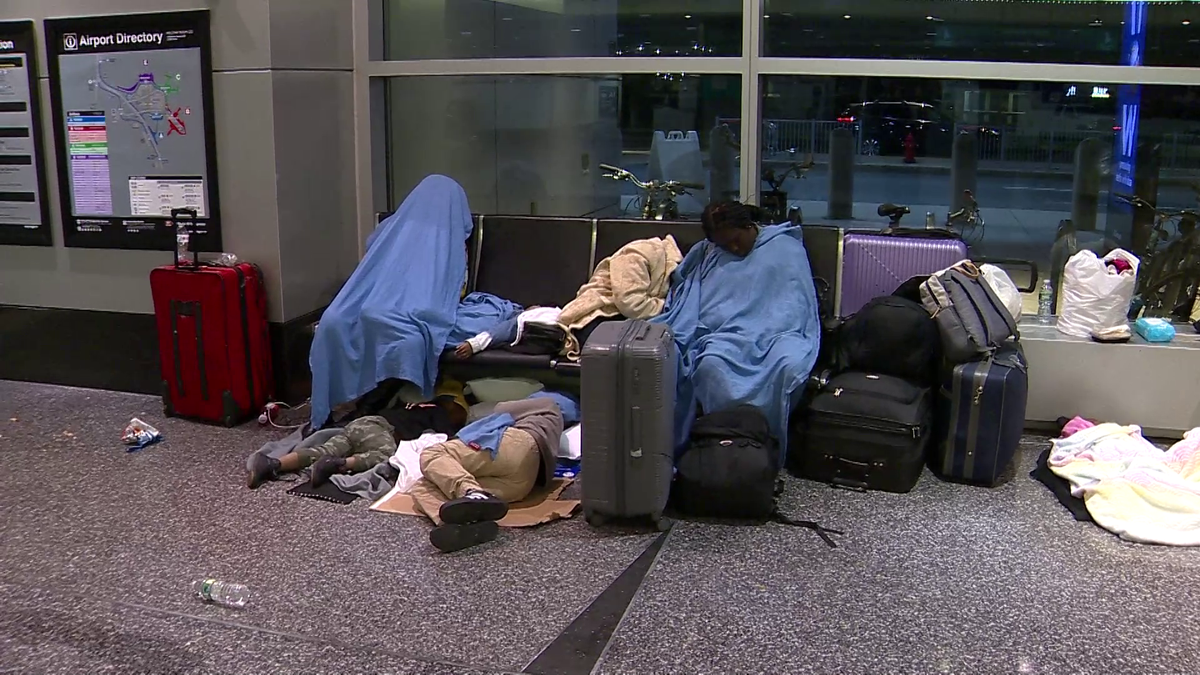 Migrant families sleeping at Logan after being turned away from shelters