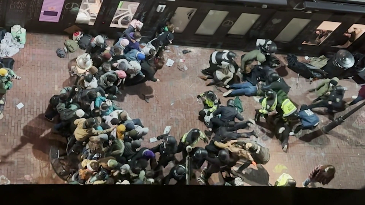 Boston police officers clear encampment at Emerson College