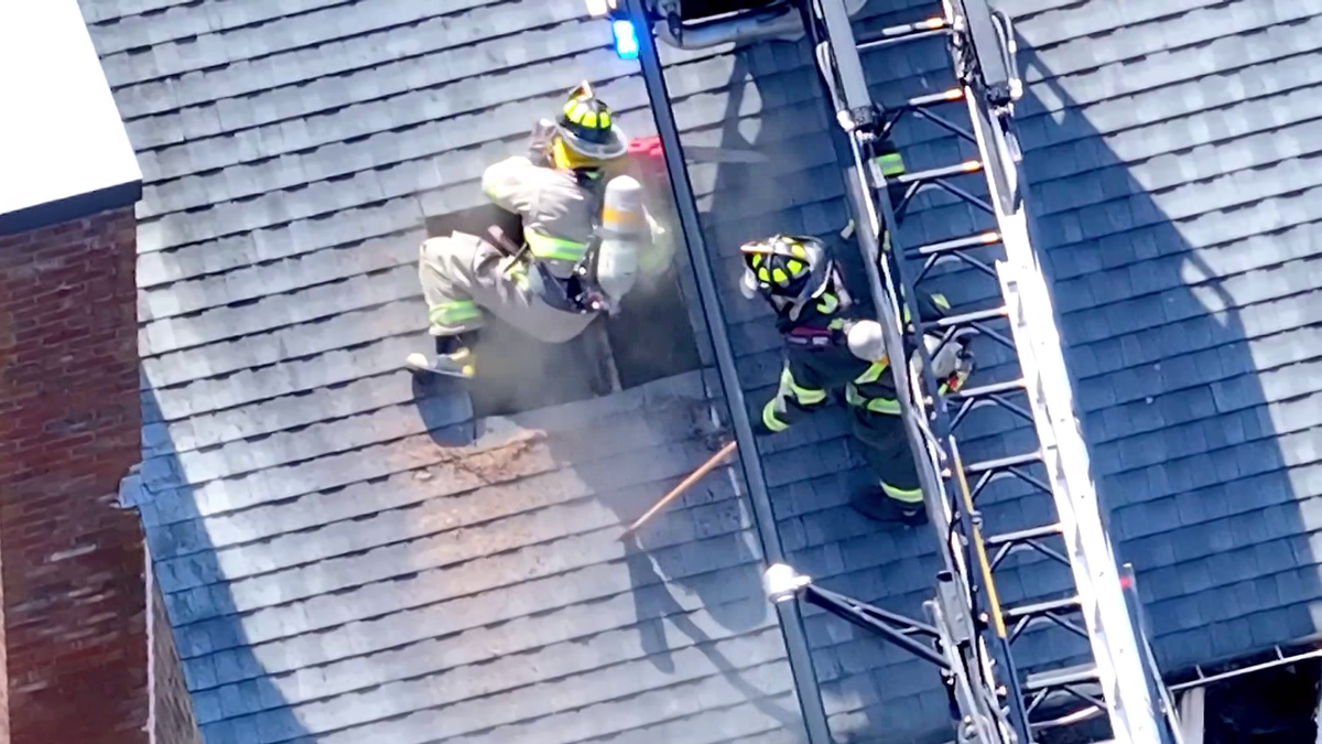 Firefighter nearly falls through roof of burning home in Onset
