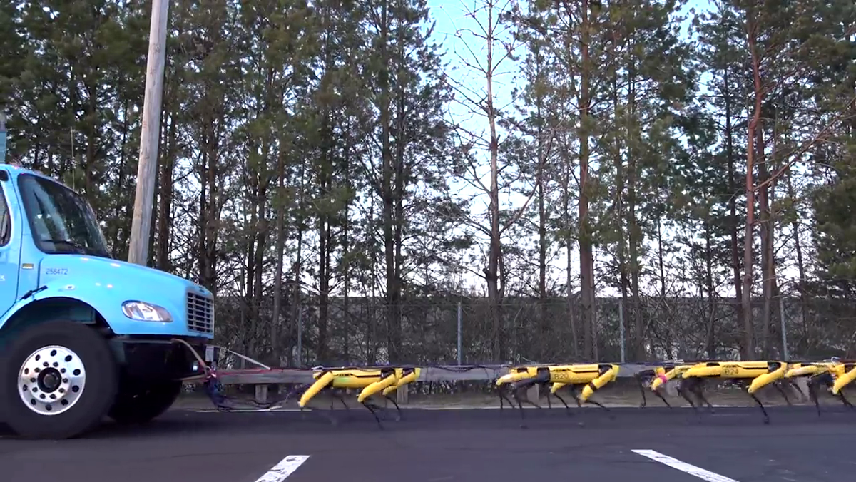 Four-legged robots pull full-size box truck