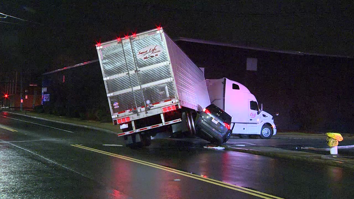 SUV becomes pinned under tractor-trailer that was making wide turn