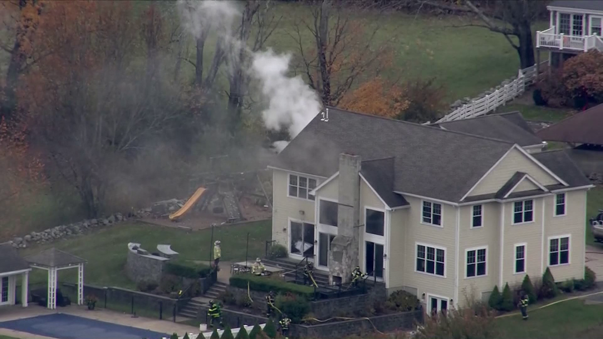 Roads closed as firefighters battle flames in Walpole home