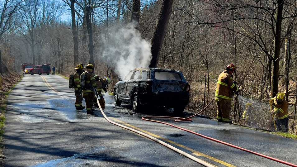 Vehicle, brush fire shuts down road in Lancaster County, Pa.
