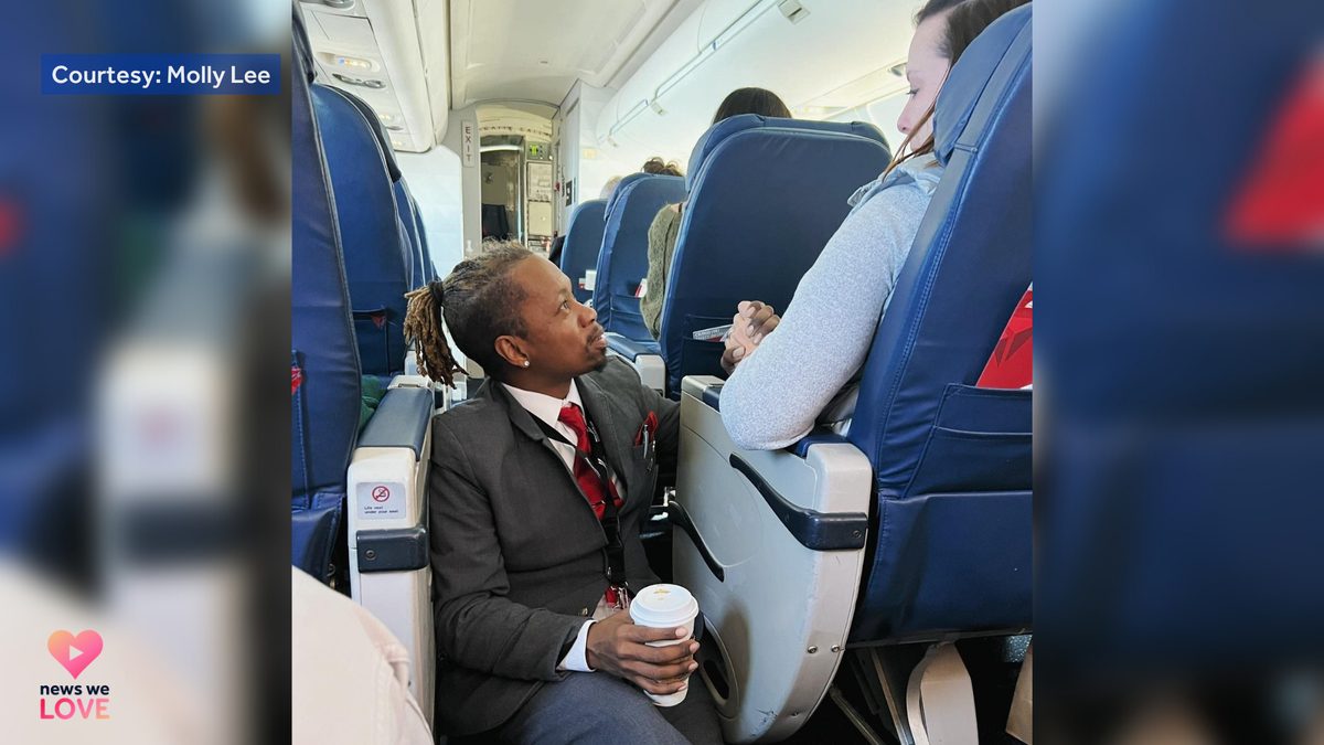 North Carolina: Flight attendant comforts a nervous passenger