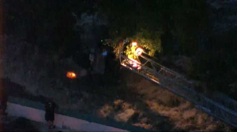 KC firefighters rescue woman from tree during flash flooding