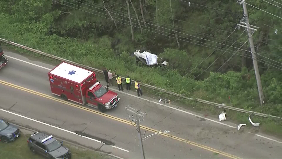1 dead after car flips over guardrail, lands in water