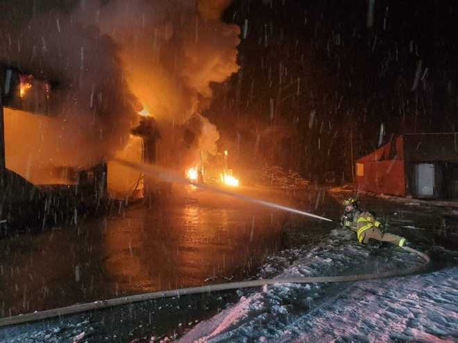 Crews battle commercial garage fire as snow falls in York