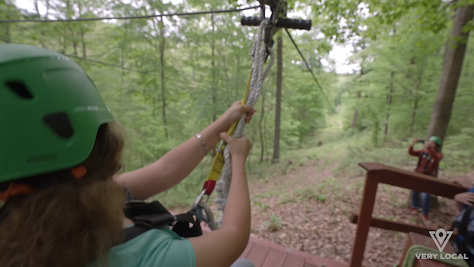 Zip line through forest canopies at this adventure park in Brown County
