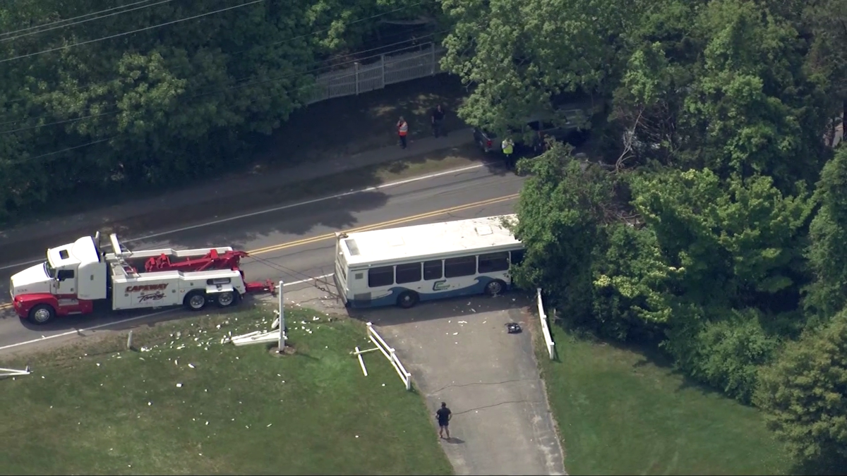 5 injured after bus crashes through fence, hits trees in Osterville
