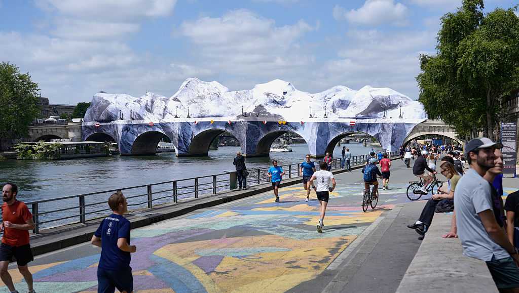 'French Banksy' creates a 'cave' installation over Paris bridge