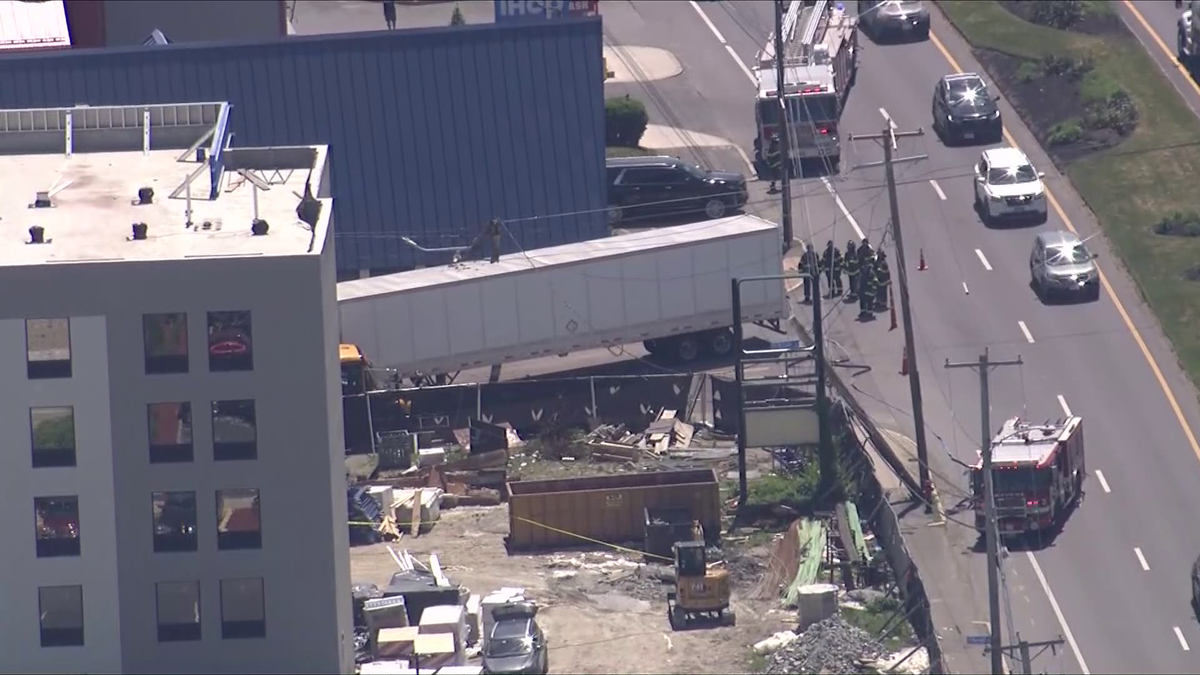 Tractor trailer pulls down poles, wires in Revere, Massachusetts