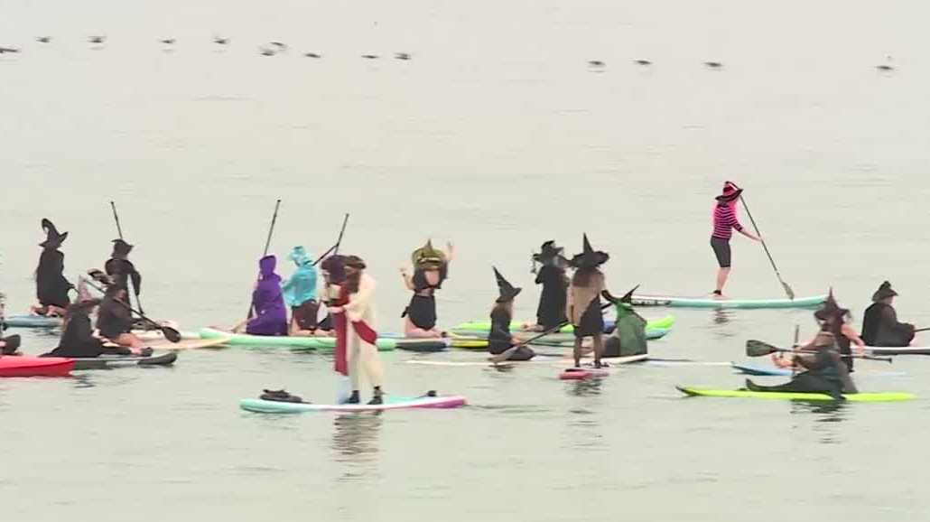 Witches paddleboard in Capitola for Halloween tradition
