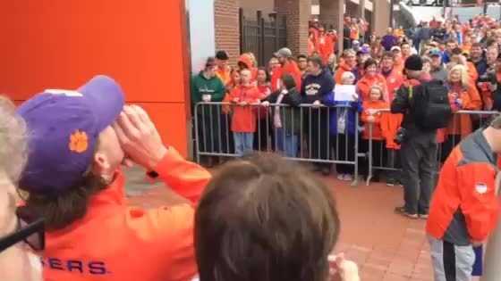 Clemson fans cheering while they wait for team to load buses