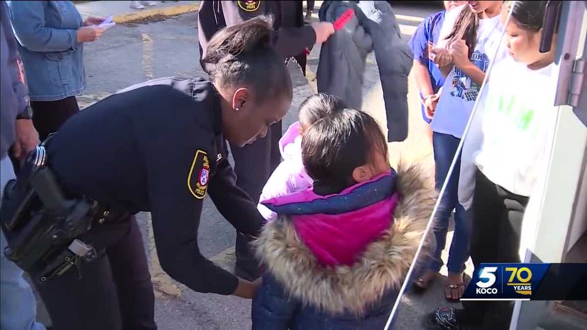 Moore police officers hand out coats to families in need