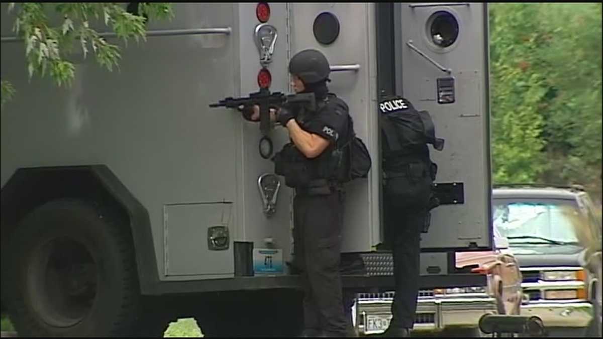 Police surround home where murder suspect may be hiding