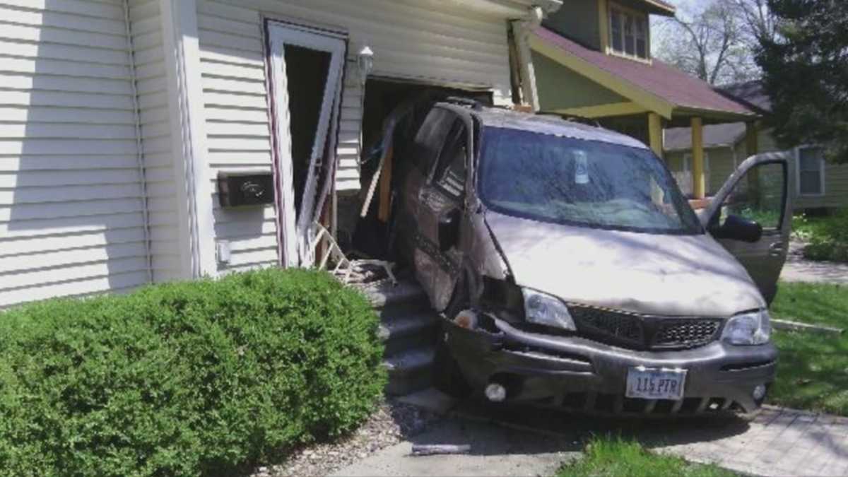 Minivan lands inside home during crash