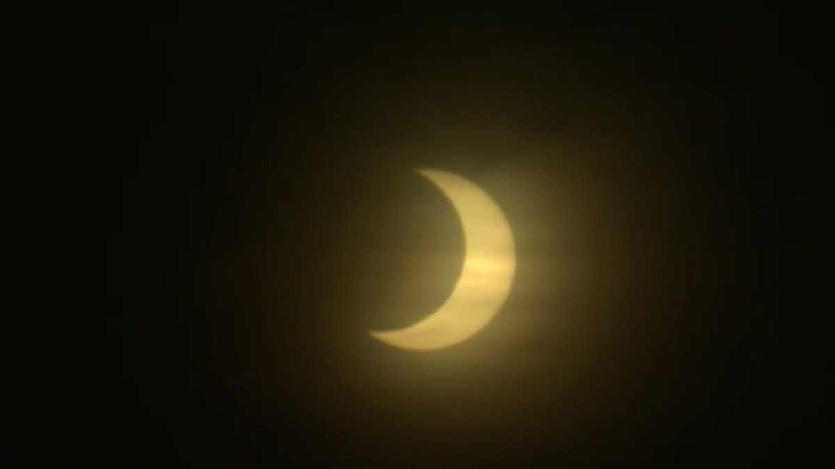 Partial solar eclipse in sky over Boston