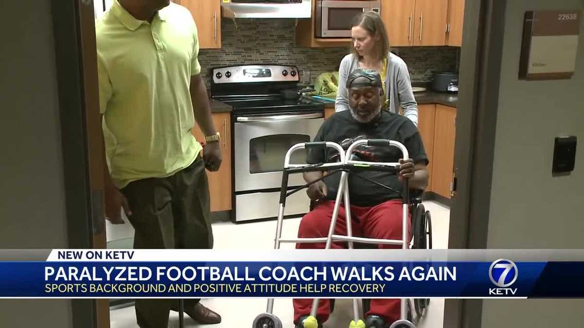 Paralyzed football coach walks again