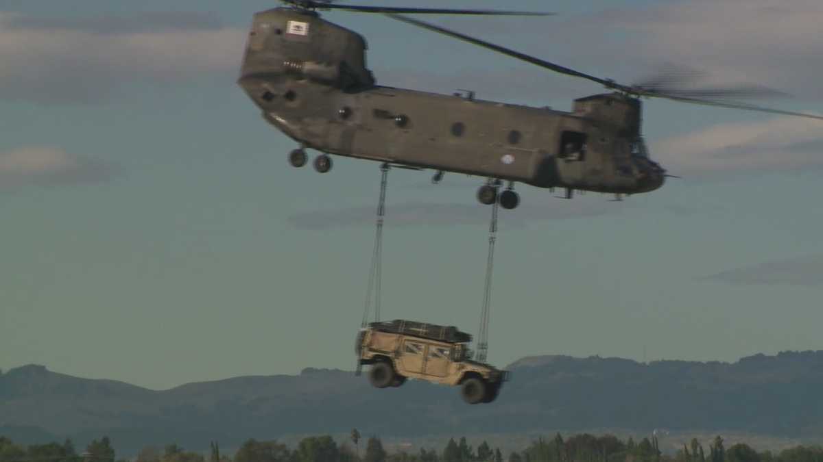 Choppers fly Humvees over the Sacramento sky