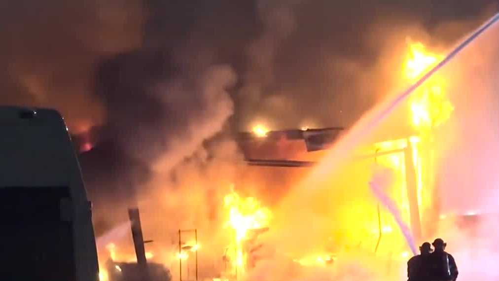 Auto repair shop and more than a dozen vehicles damaged in fire