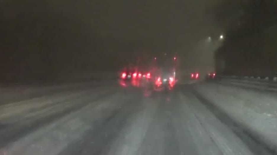 Snow falls off highway overpass onto car below