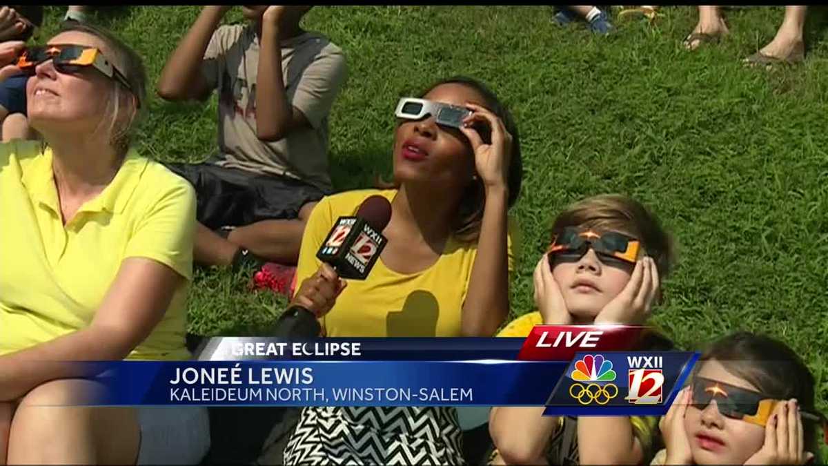 Jonee' Lewis watches the eclipse with local children in Winston-Salem