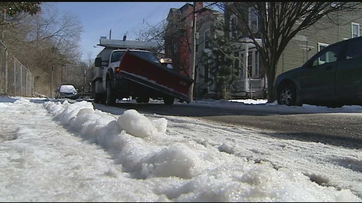 Snow-covered sidewalks causing many pedestrians to walk on the streets