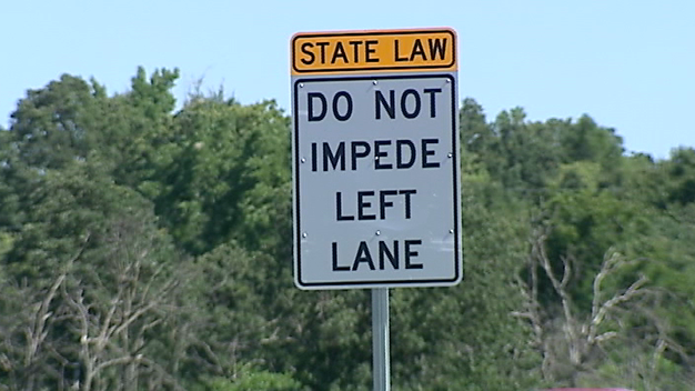 Highway signs reminding driver to not use left lane unless passing