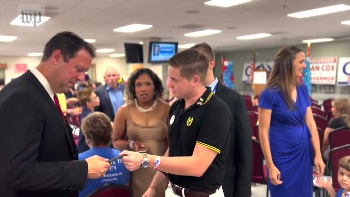 Video shows Dan Cox meeting Proud Boys member, accepting gift