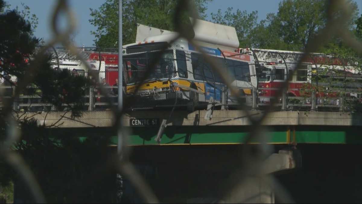 MBTA bus crashes through guardrail, hangs over Mass Pike