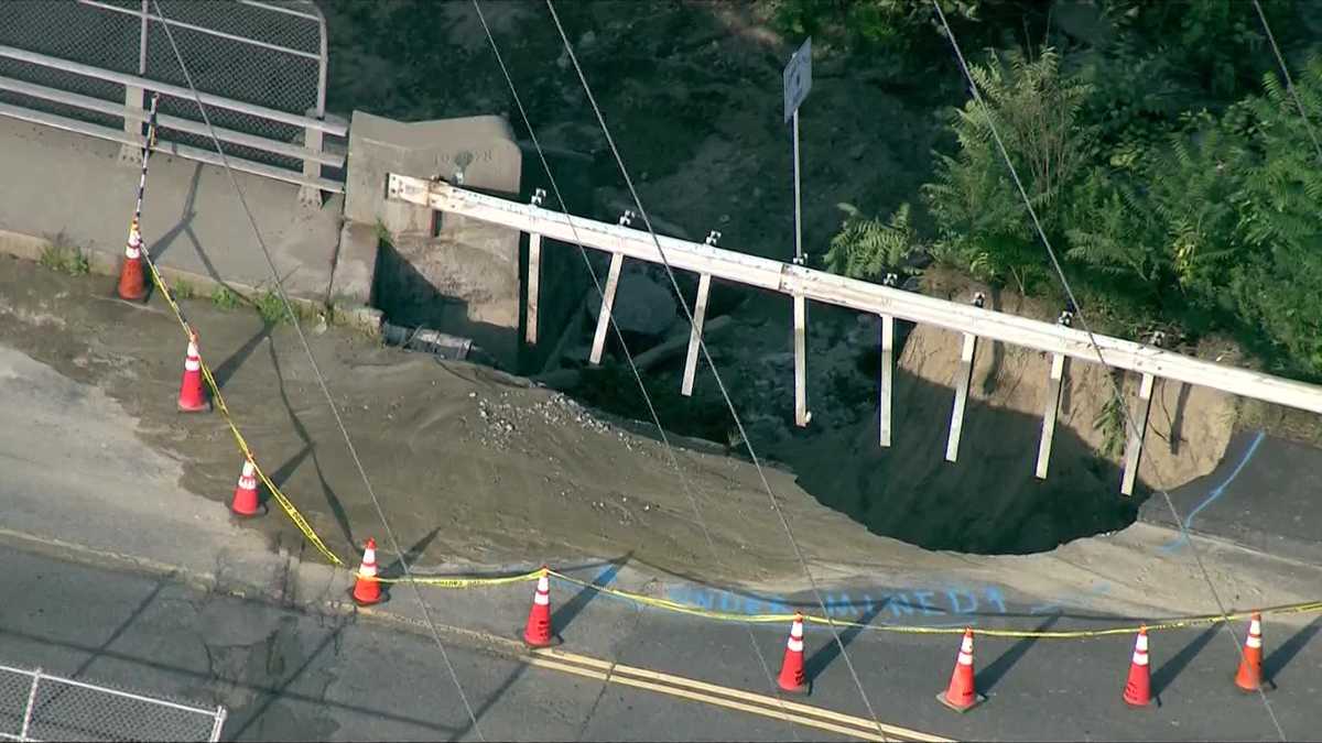 Water main break causes part of Worcester road near bridge to wash away