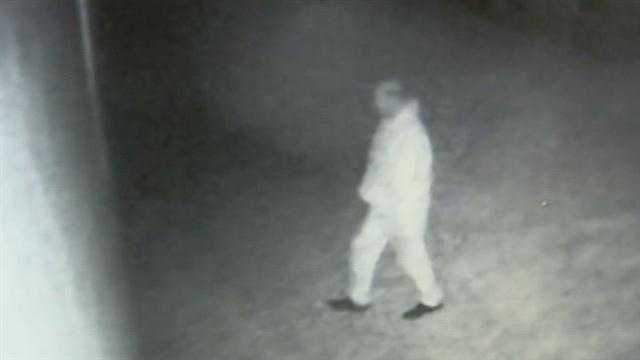 Surveillance video captures man peeping through window