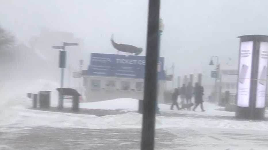 Strong winds blow snow off roads, sidewalks in Boston