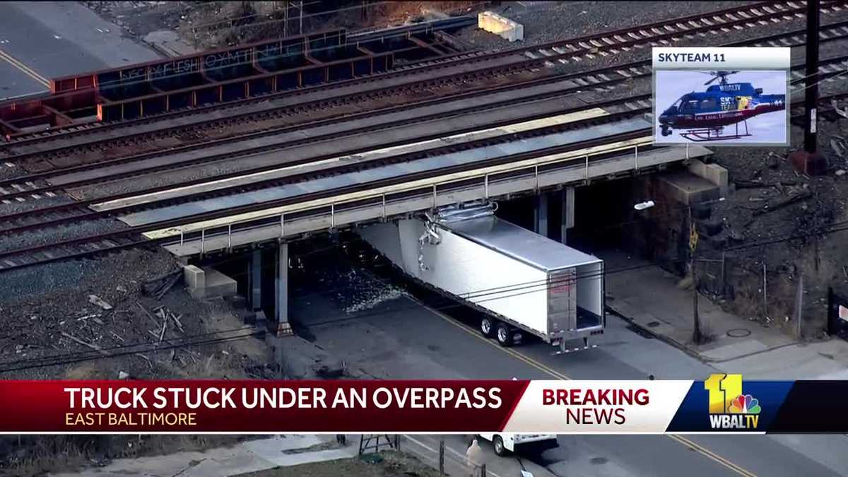Tractor-trailer stuck under railroad overpass