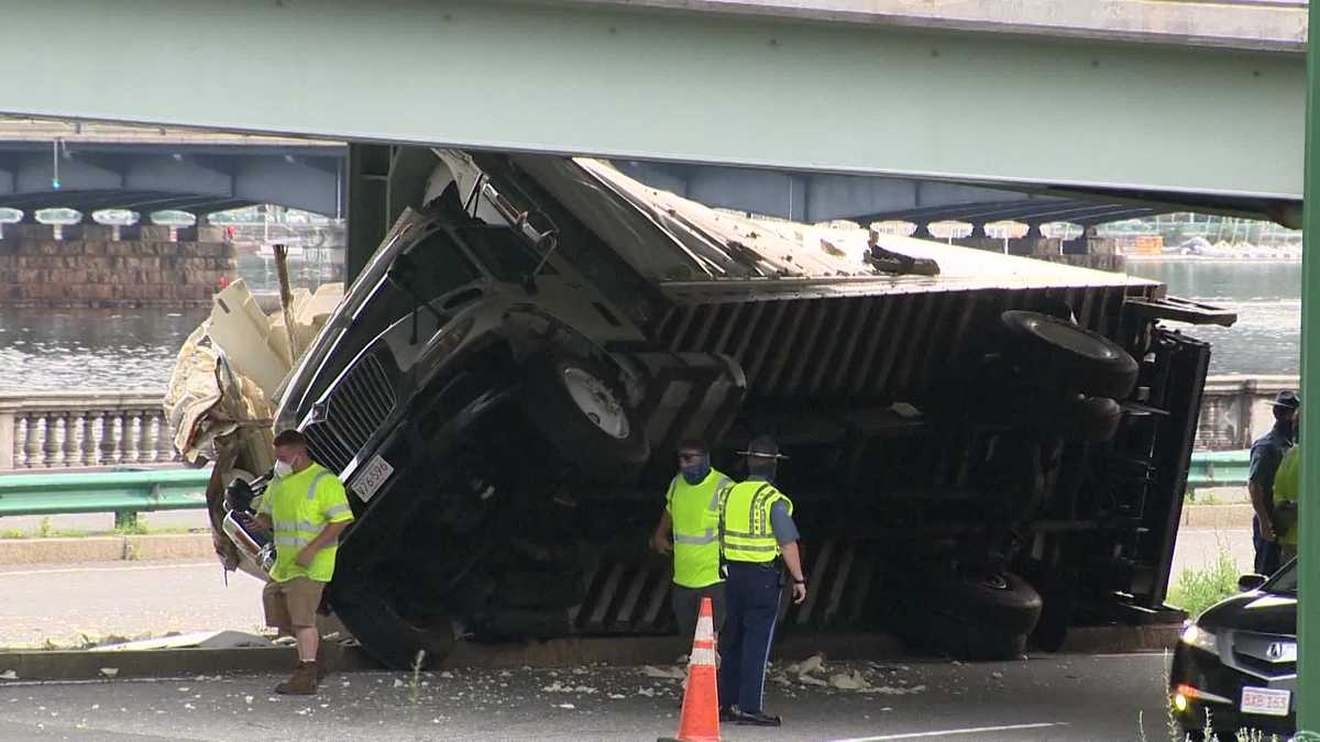 Truck hits Storrow bridge, lands on side