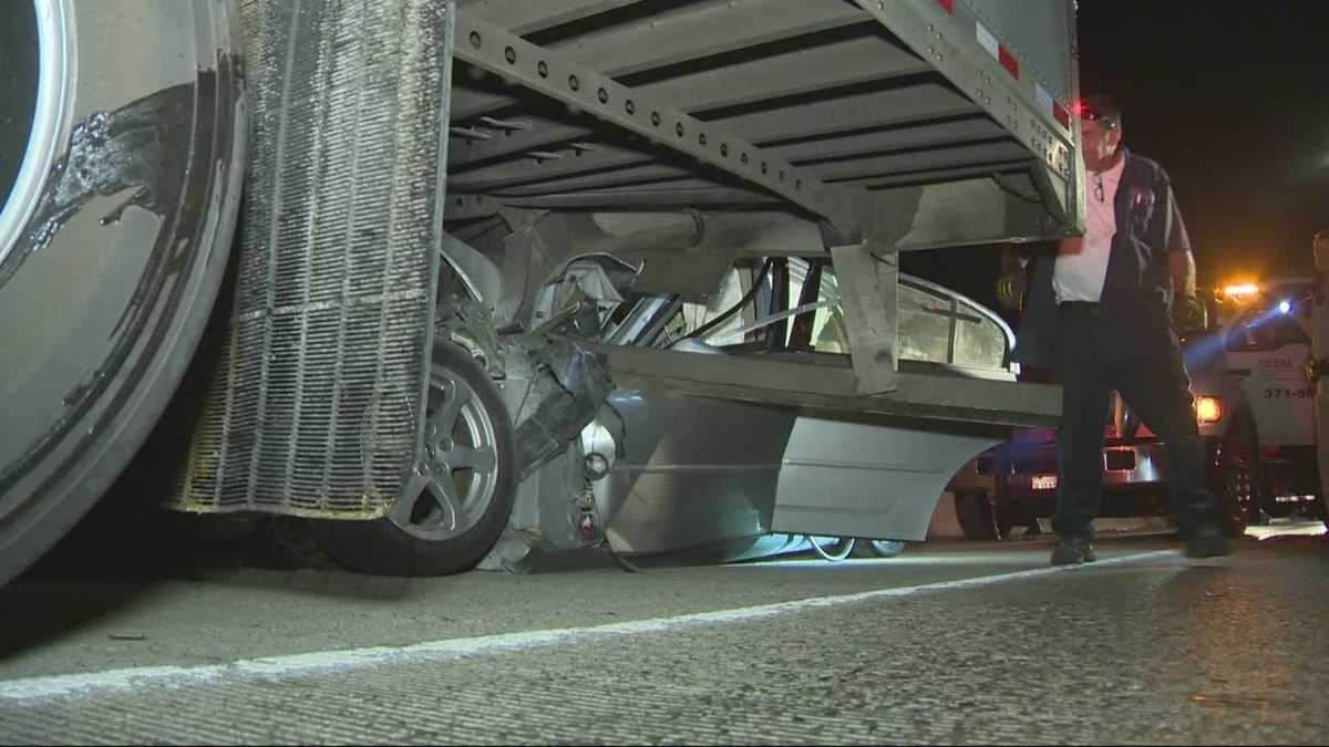 Car pinned under truck in fiery crash