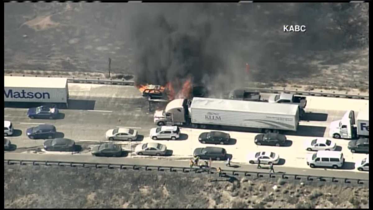 Wildfire sweeps across highway, destroys vehicles, trucks