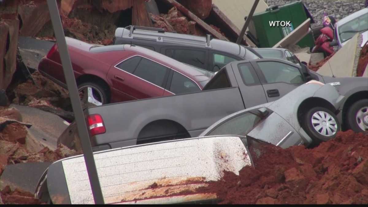 Parking lot collapses under customers' cars