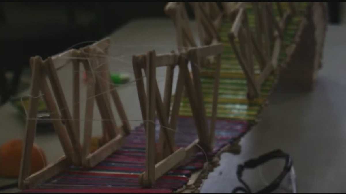 Students build popsicle stick bridges