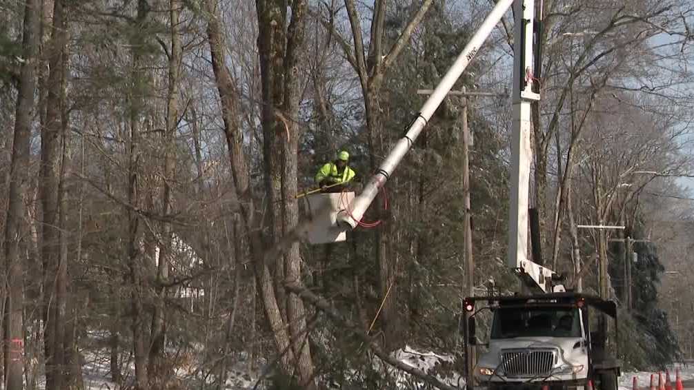 Utility crews cleaning up fallen branches in order to restore power