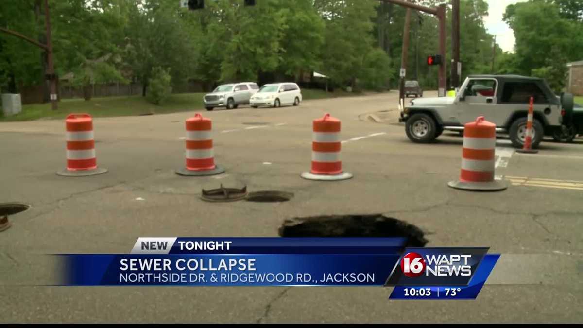 Hole opens up in road from sewer collapse