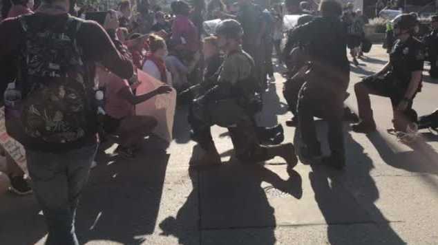 Powerful video: Omaha police kneel with, embrace protesters at 13th and ...
