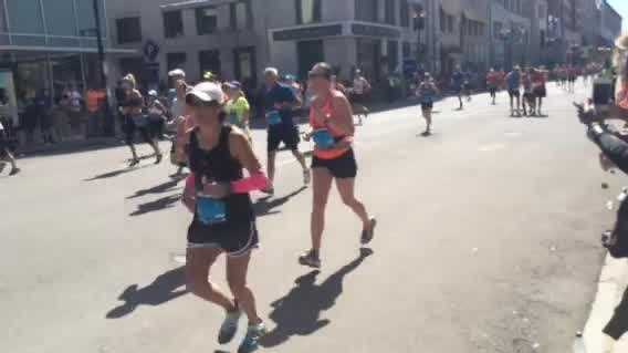 Runners help one of their own cross finish line