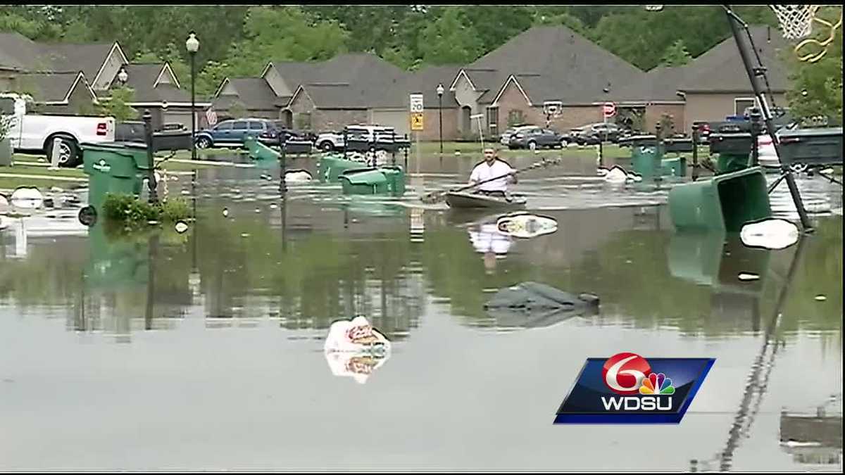 Man uses canoe to get around flooded neighborhood in Robert