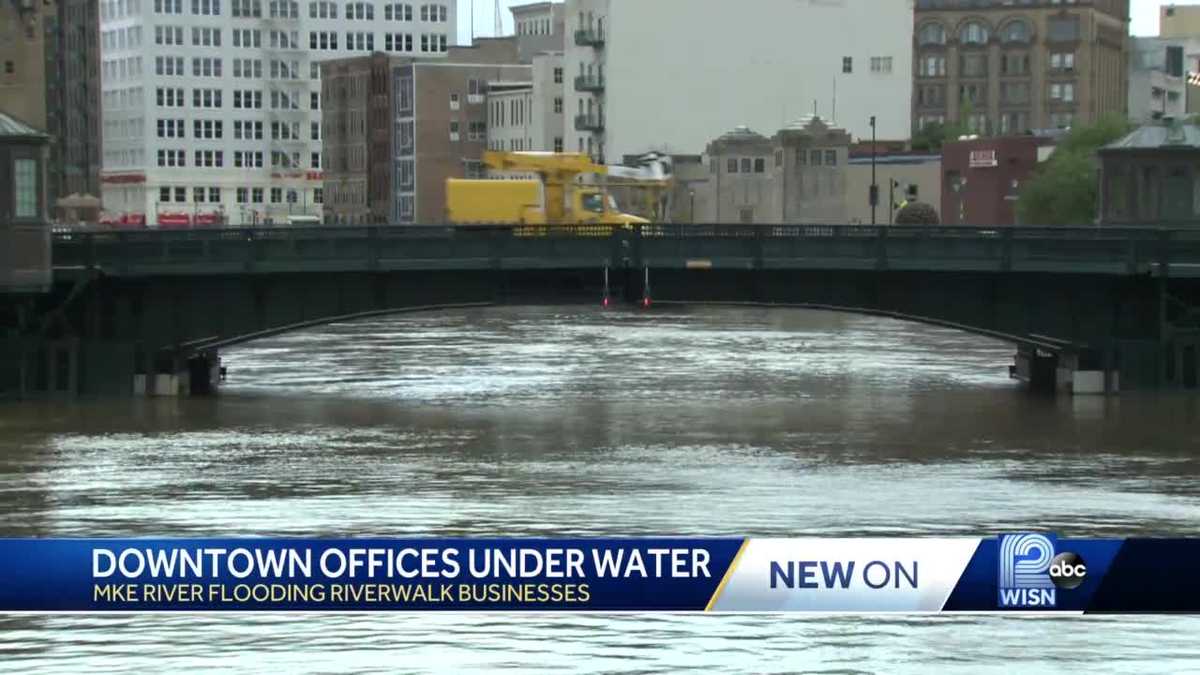 Rising Milwaukee River flows into downtown offices