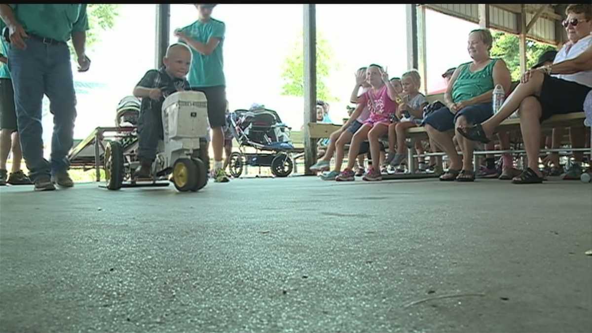 Girl competes in pedal tractor pull at fair after battling cancer in ...