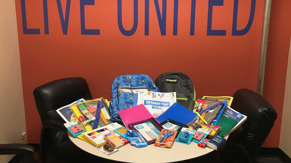 Volunteers fill hundreds of backpacks with supplies for children